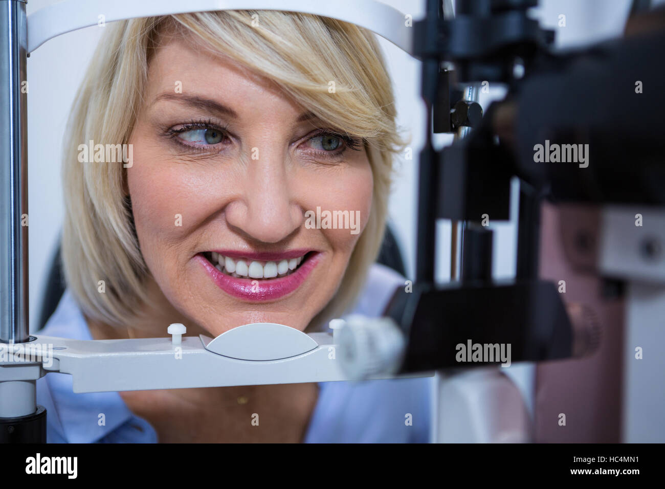 Female patient under going eye test on slit lamp Stock Photo - Alamy