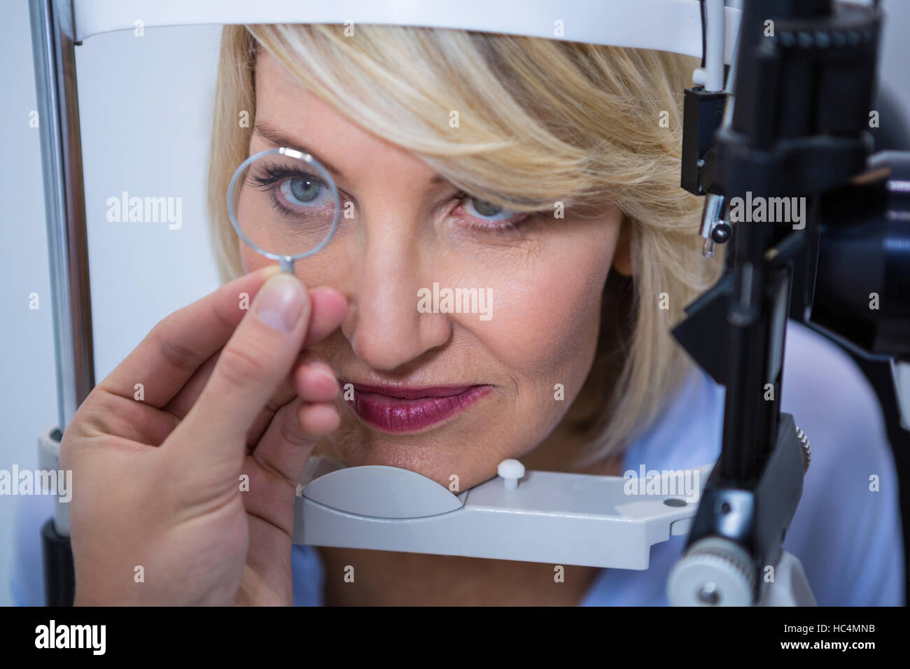 Female patient under going eye test on slit lamp Stock Photo - Alamy