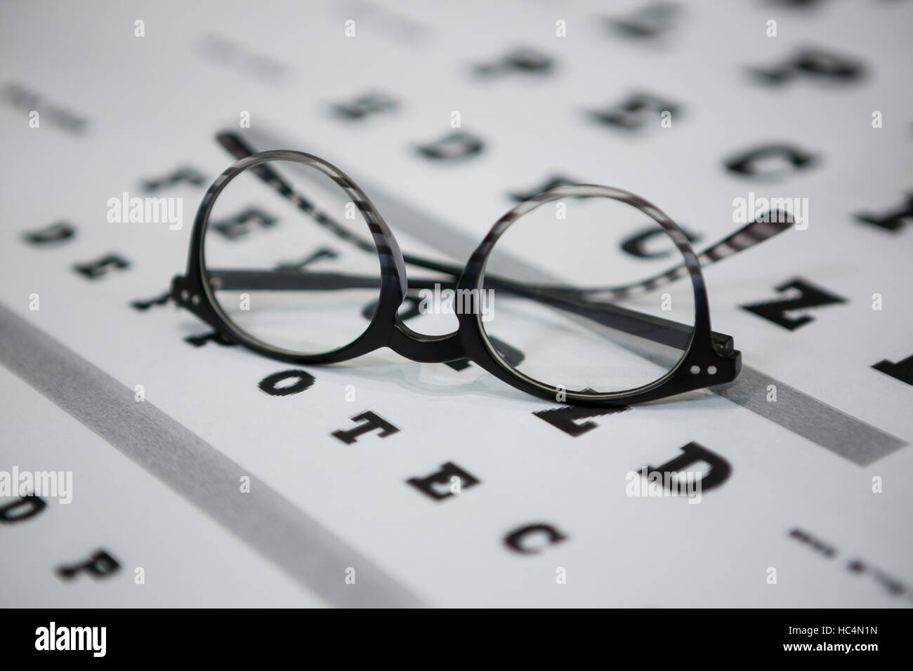 Close-up of spectacles on eye chart Stock Photo - Alamy