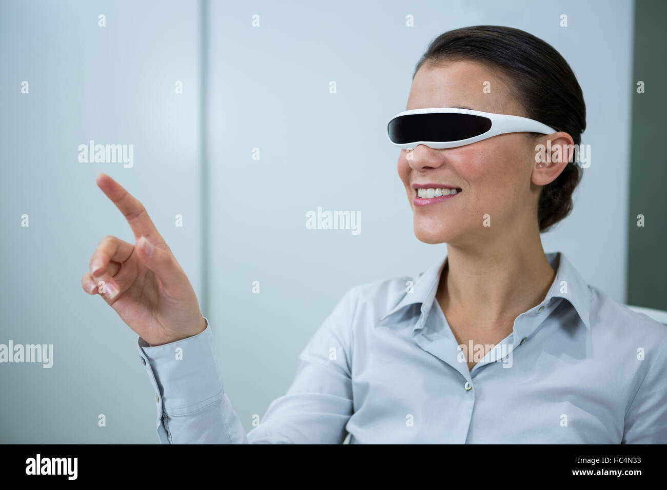Woman using virtual video glasses Stock Photo - Alamy