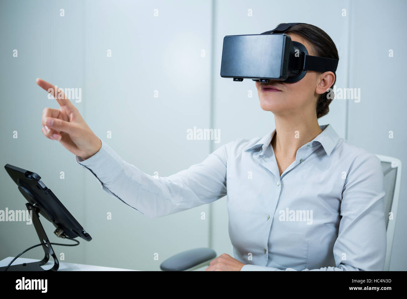 Woman using virtual reality headset Stock Photo - Alamy