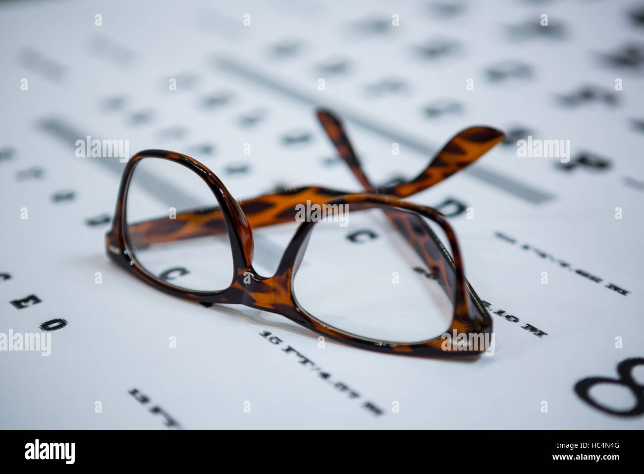 Close-up of spectacles on eye chart Stock Photo - Alamy