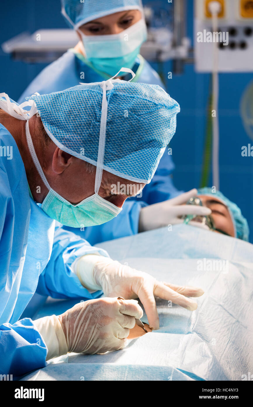 Elderly doctor performing surgery hi-res stock photography and images ...