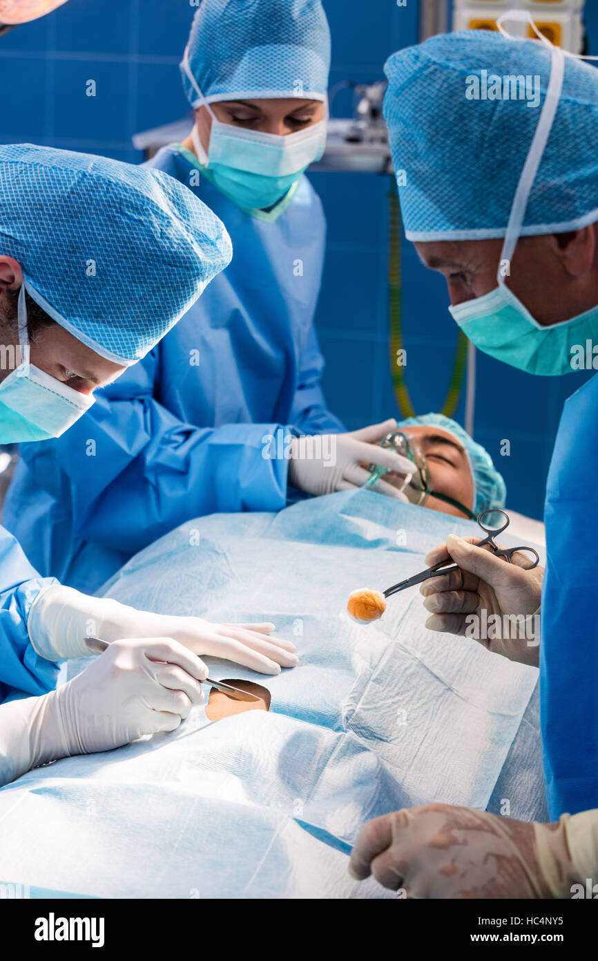 Surgeons performing operation in operation room Stock Photo - Alamy