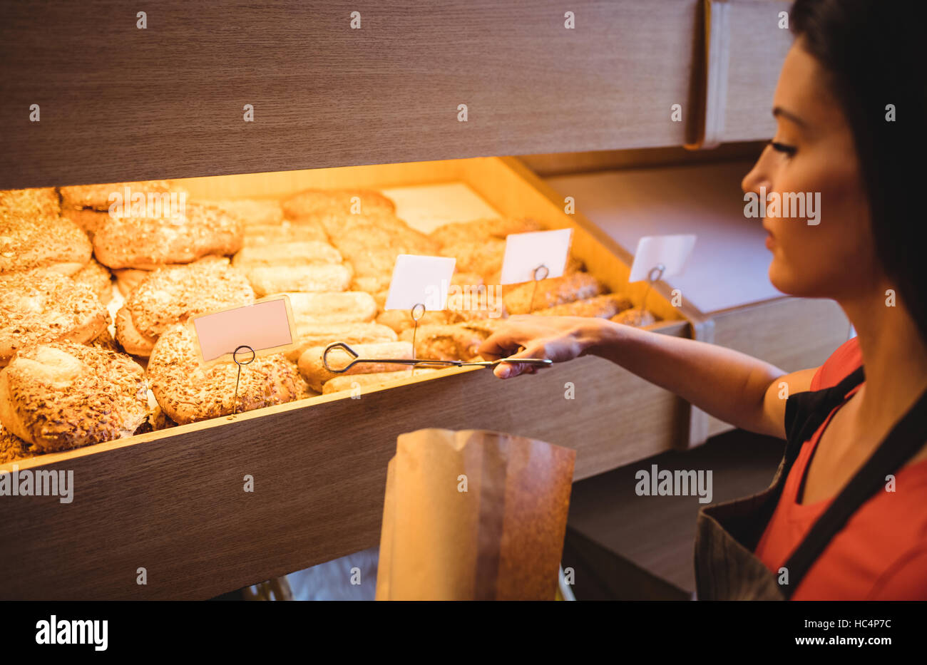 Female baker packing sweet food Stock Photo - Alamy