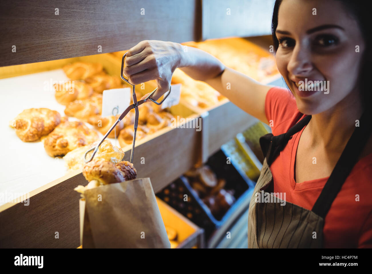 Female baker packing sweet food Stock Photo - Alamy