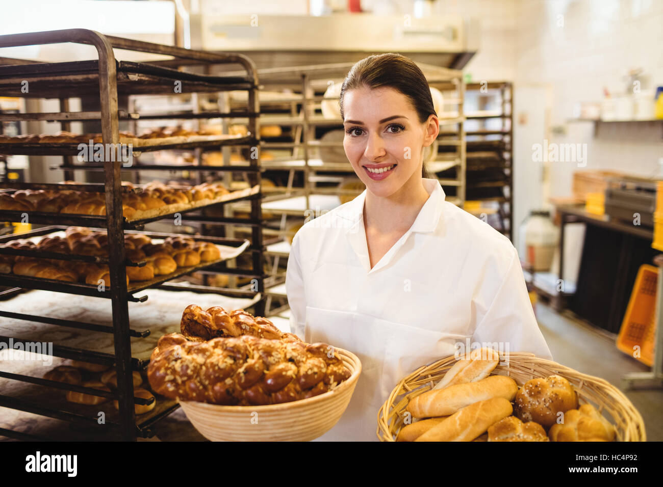 Female baker holding basket of sweet foods Stock Photo - Alamy