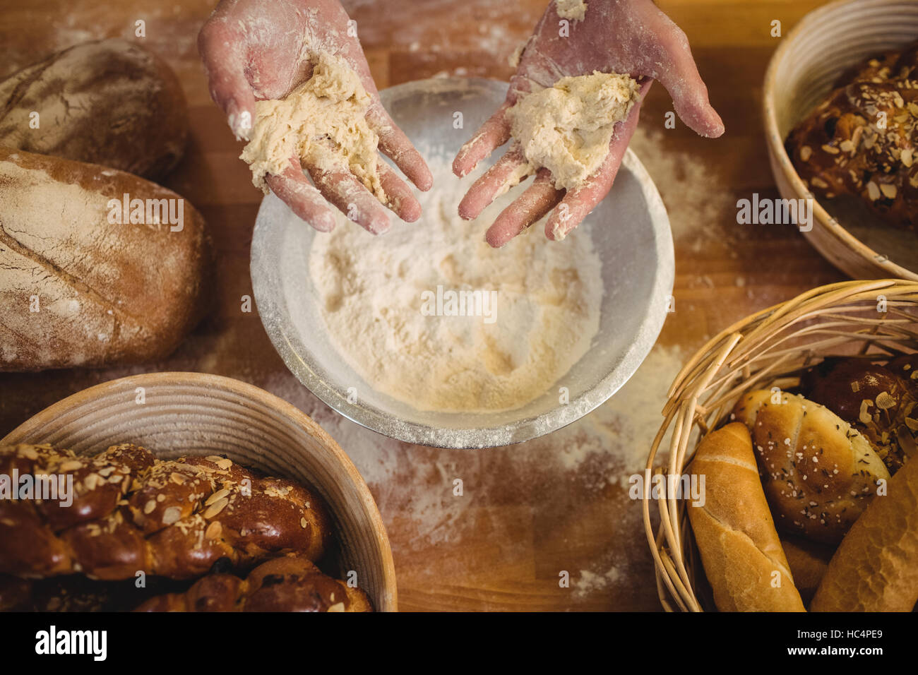 Hands of baker mixing flour by hand Stock Photo - Alamy