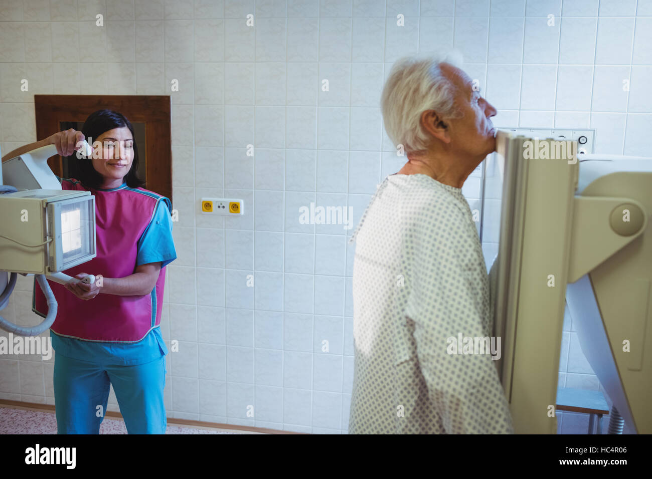 Female doctor sets up the machine to x-ray a patients spine Stock Photo ...