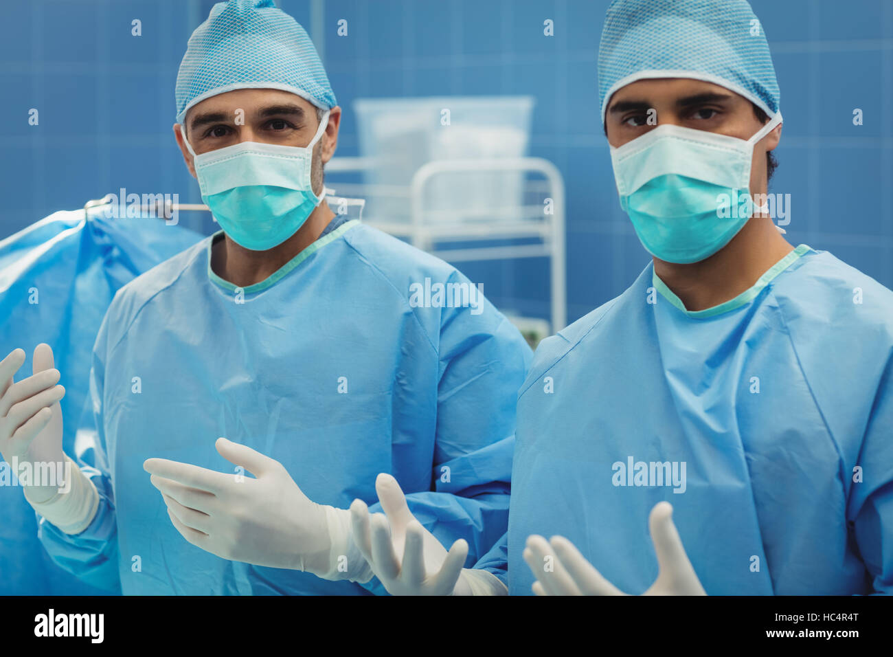 Portrait of male surgeons preparing for operation in operation room ...