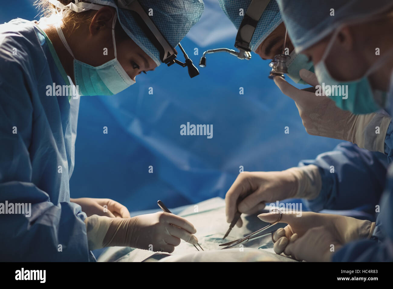 Surgeons performing operation in operation room Stock Photo - Alamy