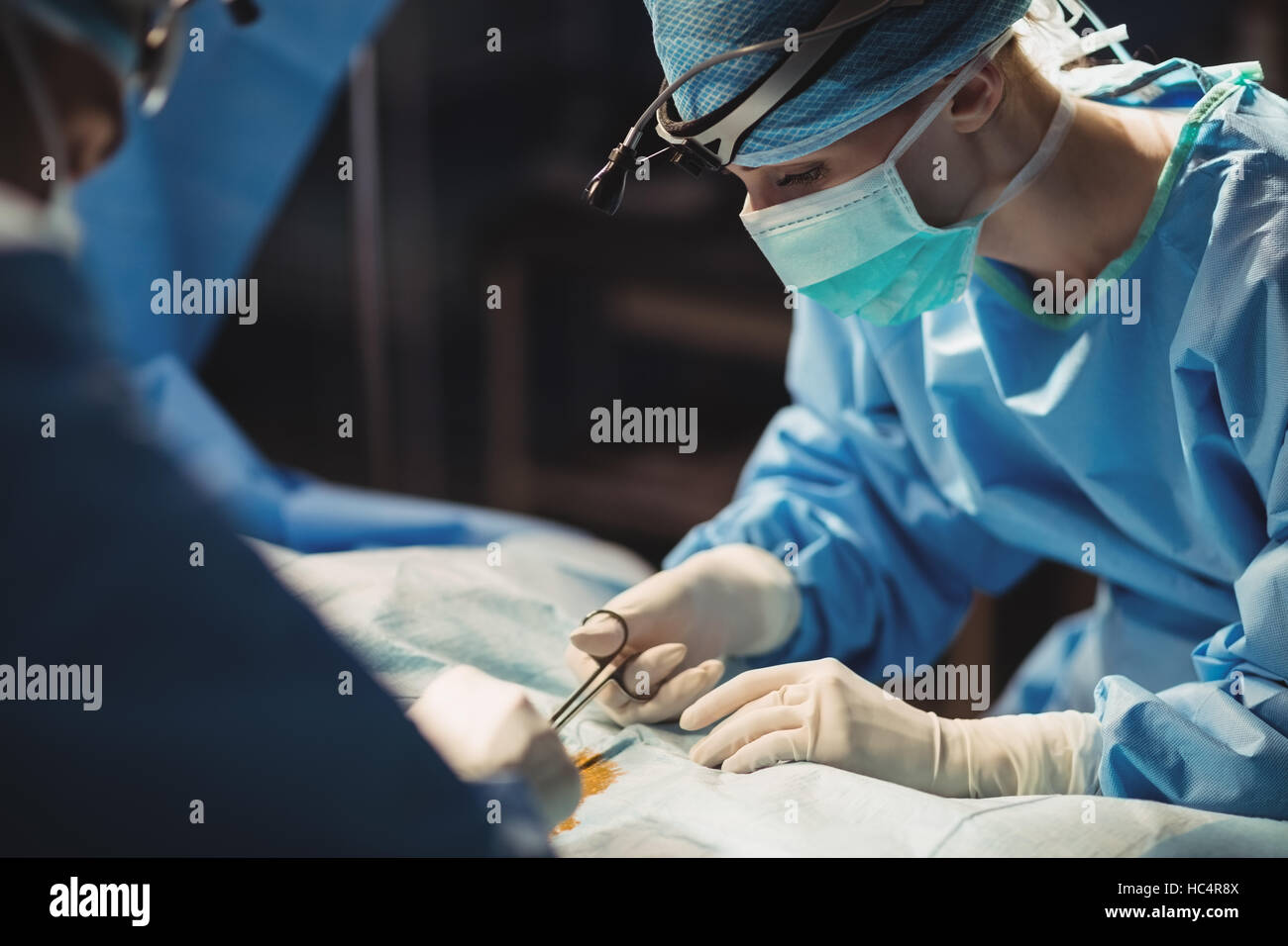 Surgeons performing operation in operation room Stock Photo - Alamy