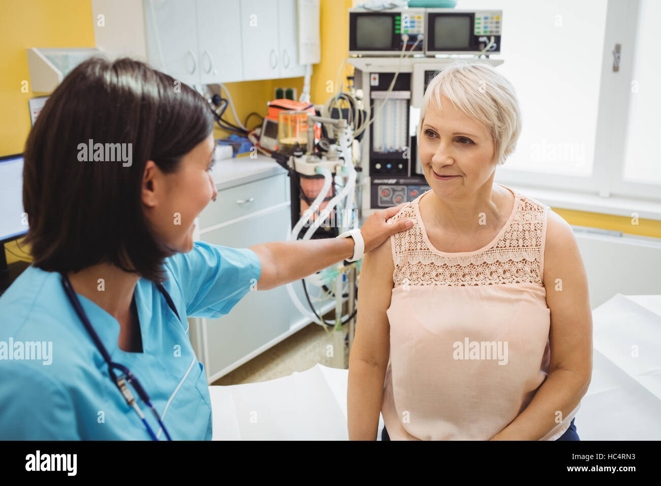 Female doctor consoling a patient Stock Photo - Alamy
