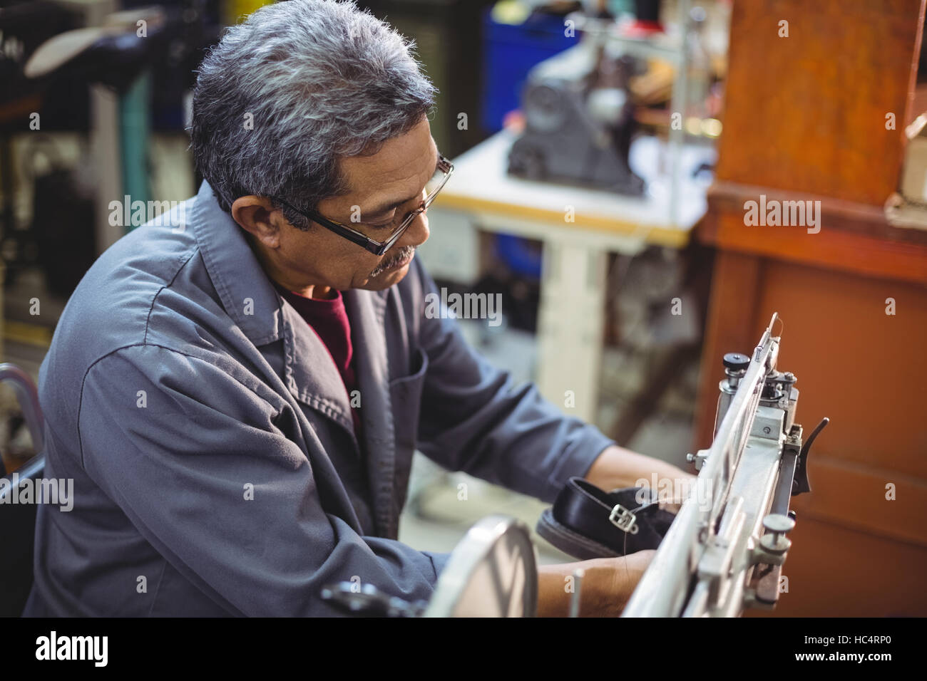 Shoemaker using sewing machine Stock Photo - Alamy