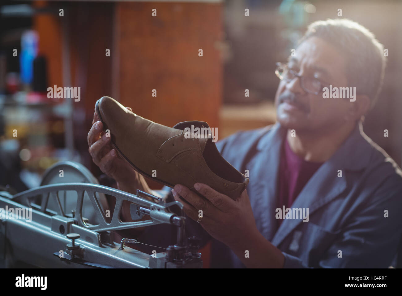Shoemaker examining a shoe Stock Photo - Alamy