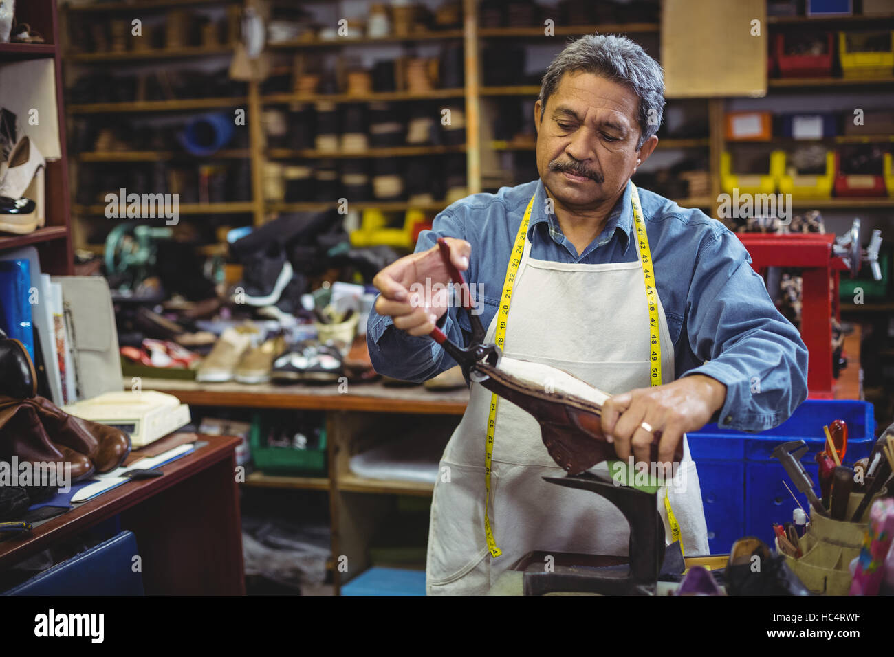 Shoemaker repairing a shoe Stock Photo - Alamy