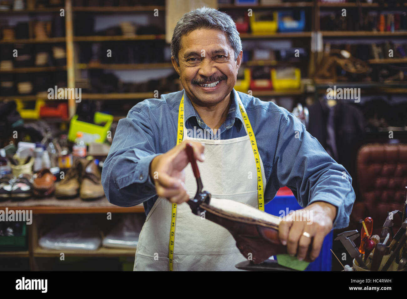 Shoemaker repairing a shoe Stock Photo - Alamy