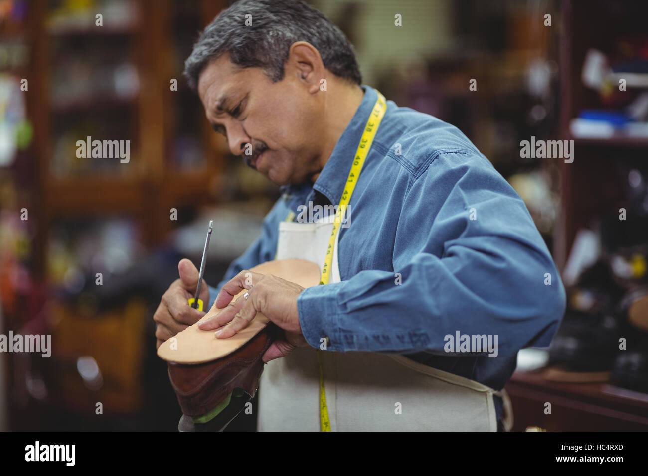 Shoemaker repairing a shoe Stock Photo - Alamy