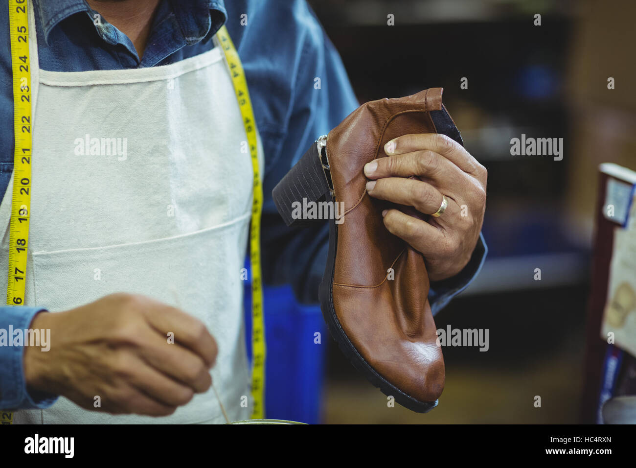 Shoemaker repairing a shoe Stock Photo - Alamy