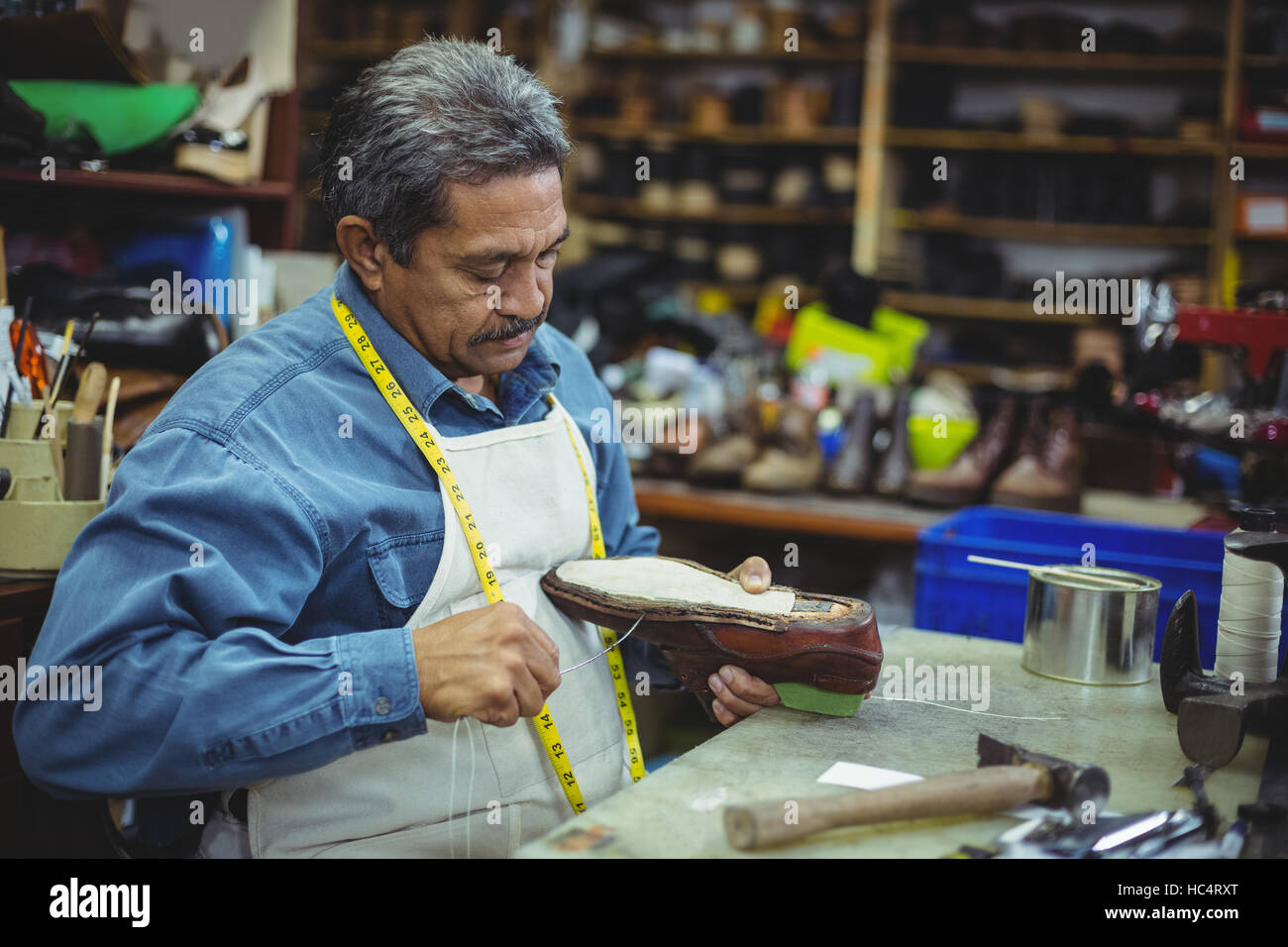 Shoemaker repairing a shoe Stock Photo - Alamy