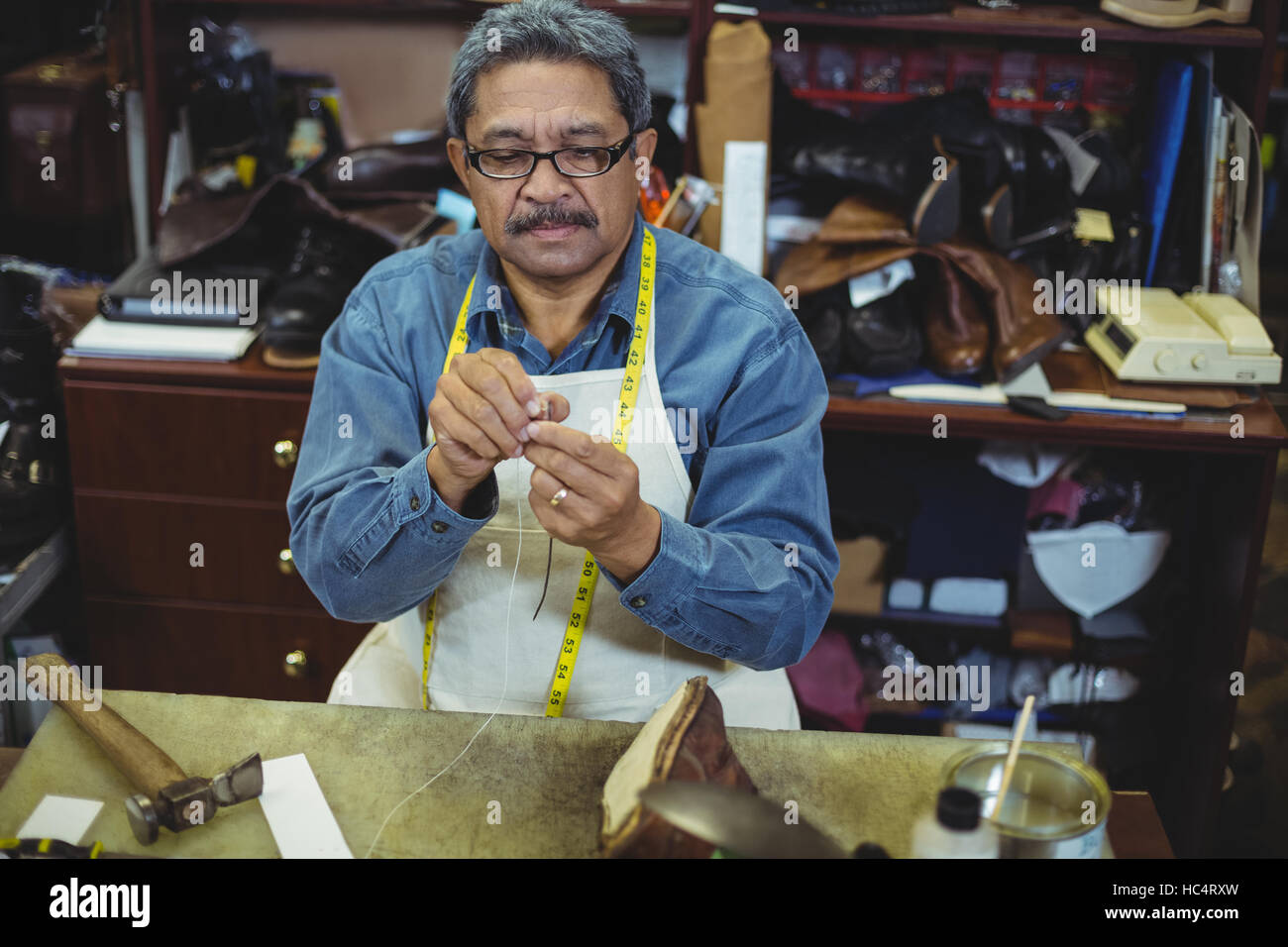 Needle and thread in leather hi-res stock photography and images - Alamy