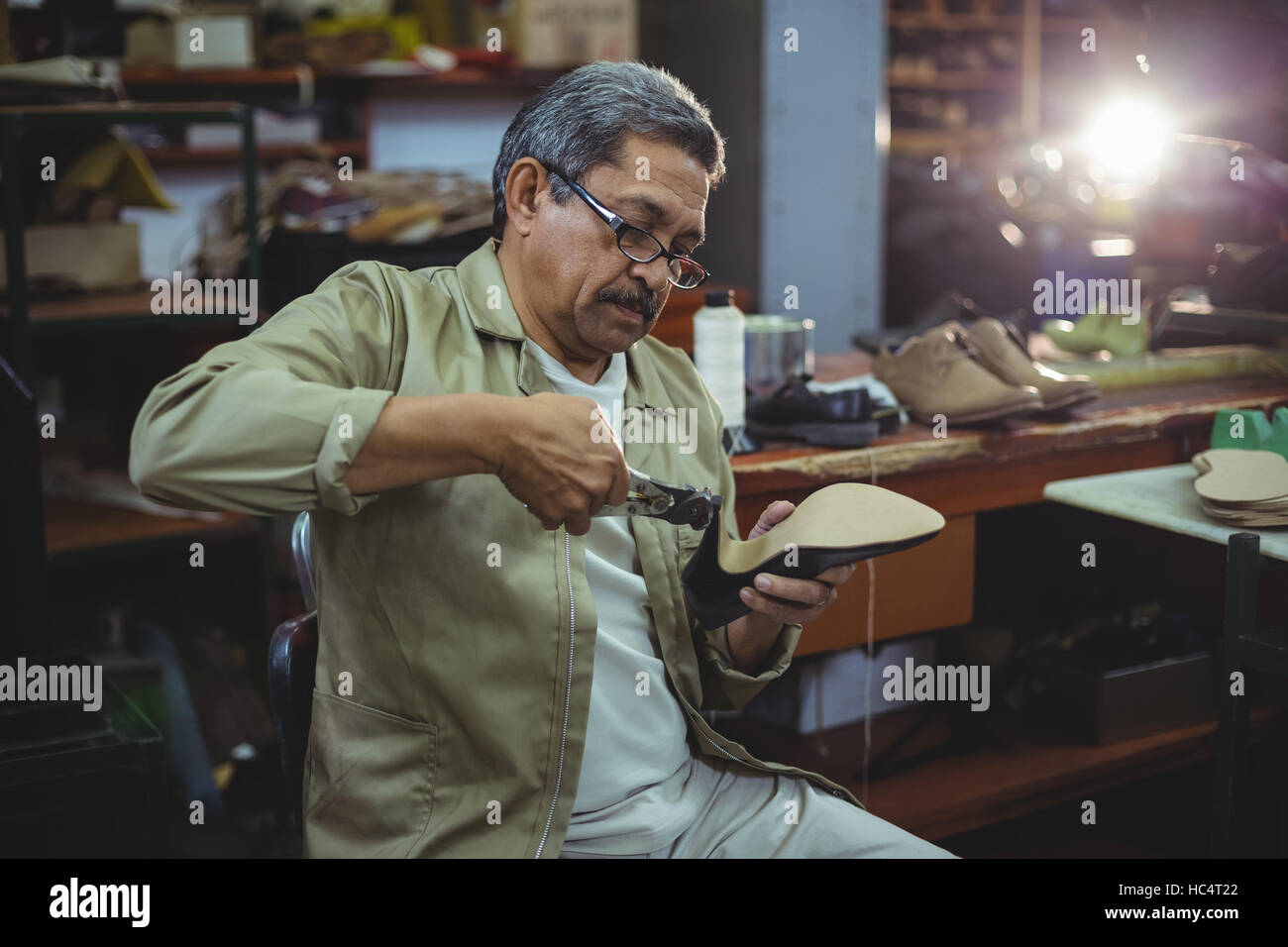 Shoemaker repairing a high heel Stock Photo - Alamy
