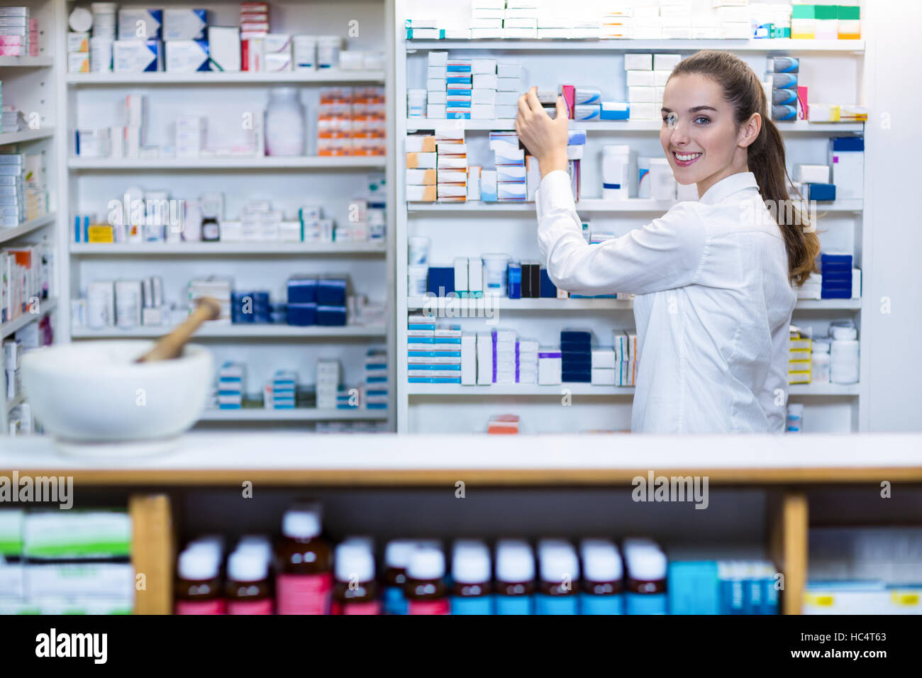 Pharmacist checking a medicine in pharmacy Stock Photo - Alamy