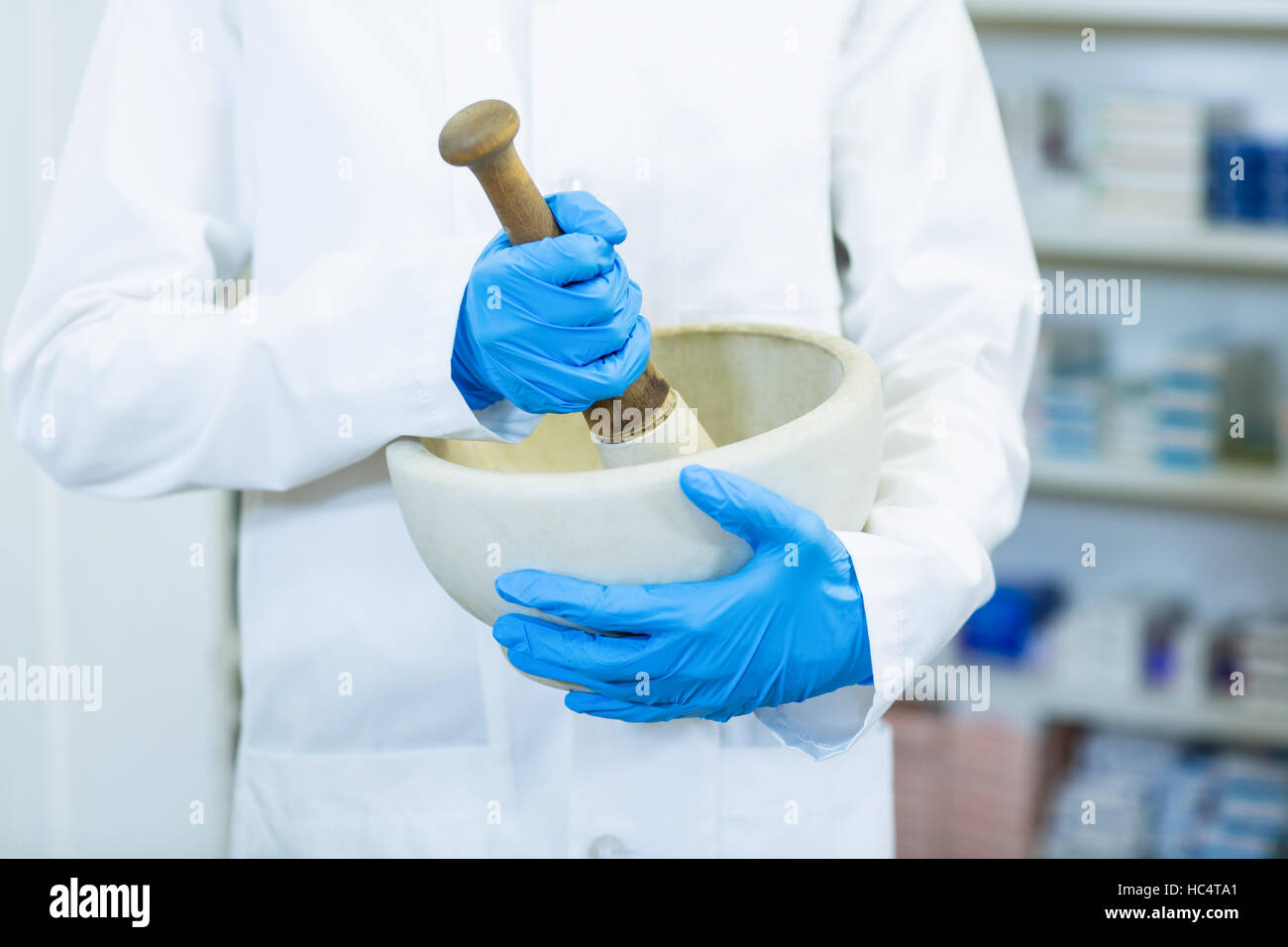 Pharmacist grinding medicine in mortal and pestle Stock Photo - Alamy