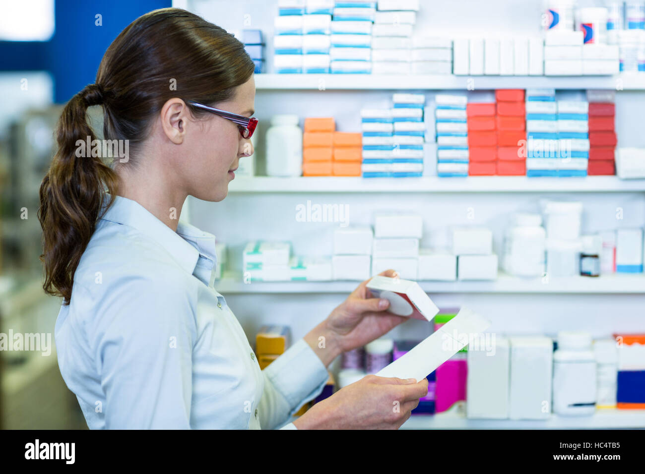 Pharmacist holding prescription while checking medicine Stock Photo - Alamy Pharmacist holding prescription while checking medicine Stock Photo - Alamy