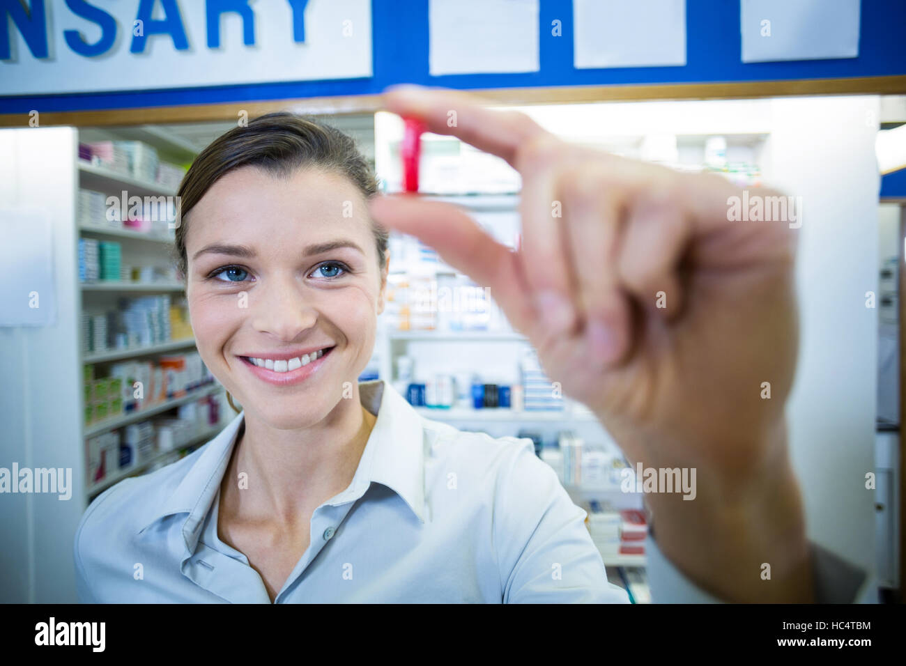 Pharmacist checking a capsule Stock Photo - Alamy