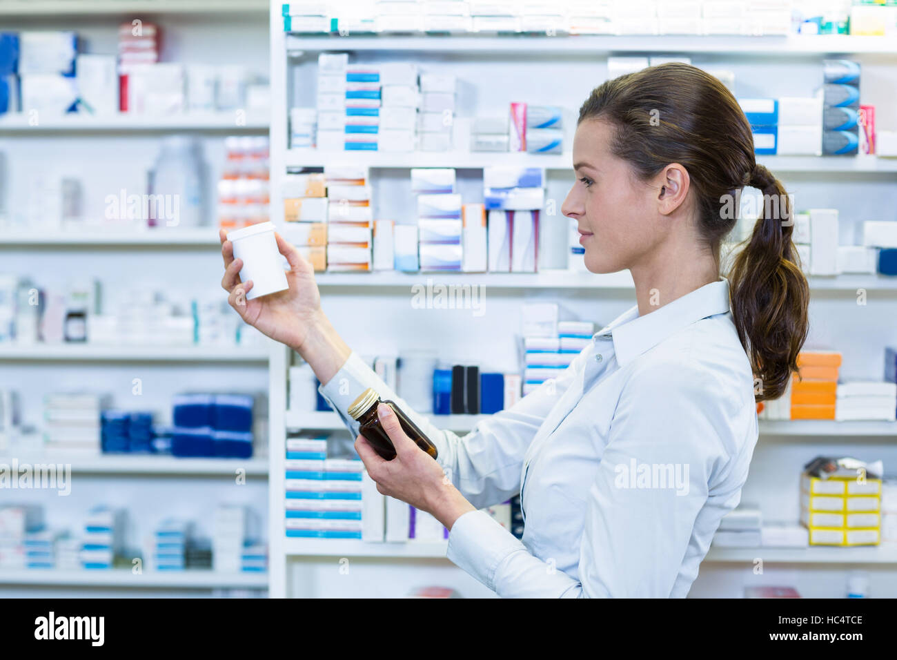 Pharmacist checking a bottle of drug Stock Photo - Alamy