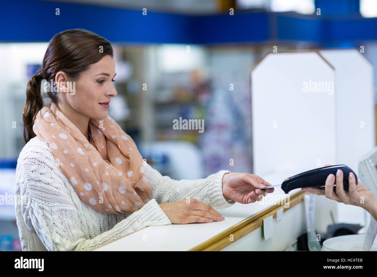 Customer making payment through payment terminal Stock Photo - Alamy