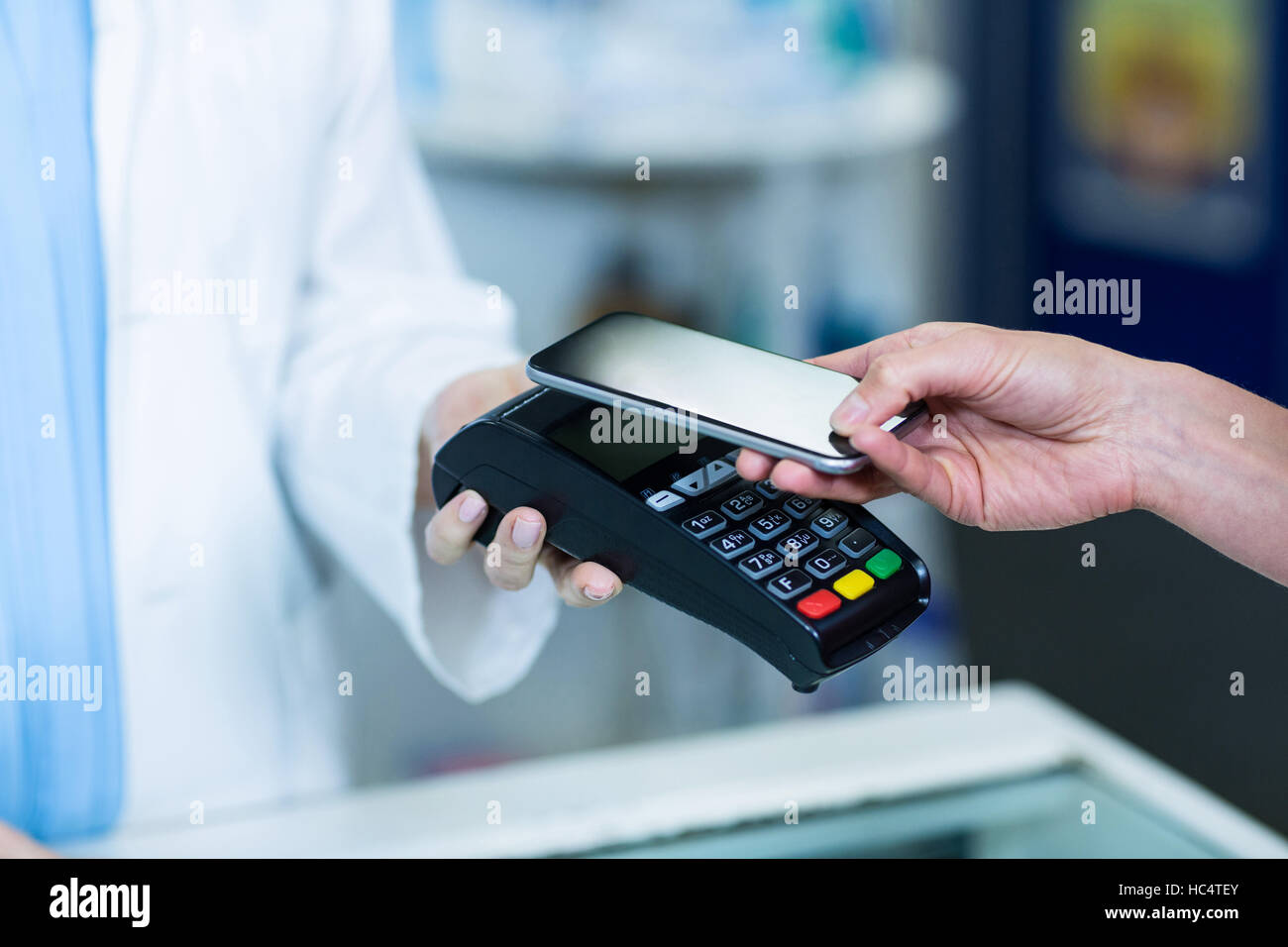 Woman paying bill through smartphone using NFC technology Stock Photo ...