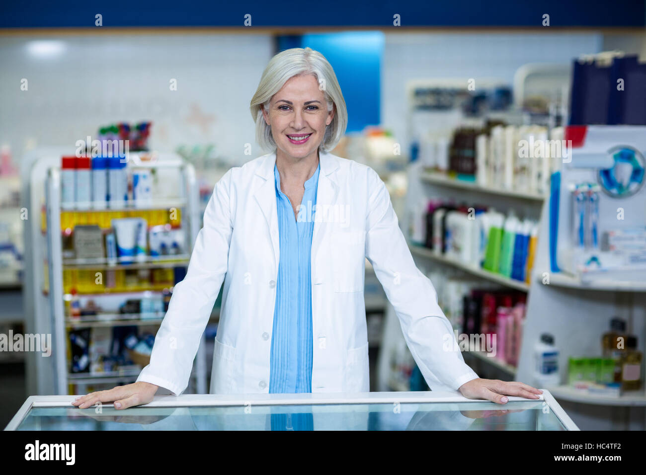 Pharmacist standing at counter in pharmacy Stock Photo - Alamy