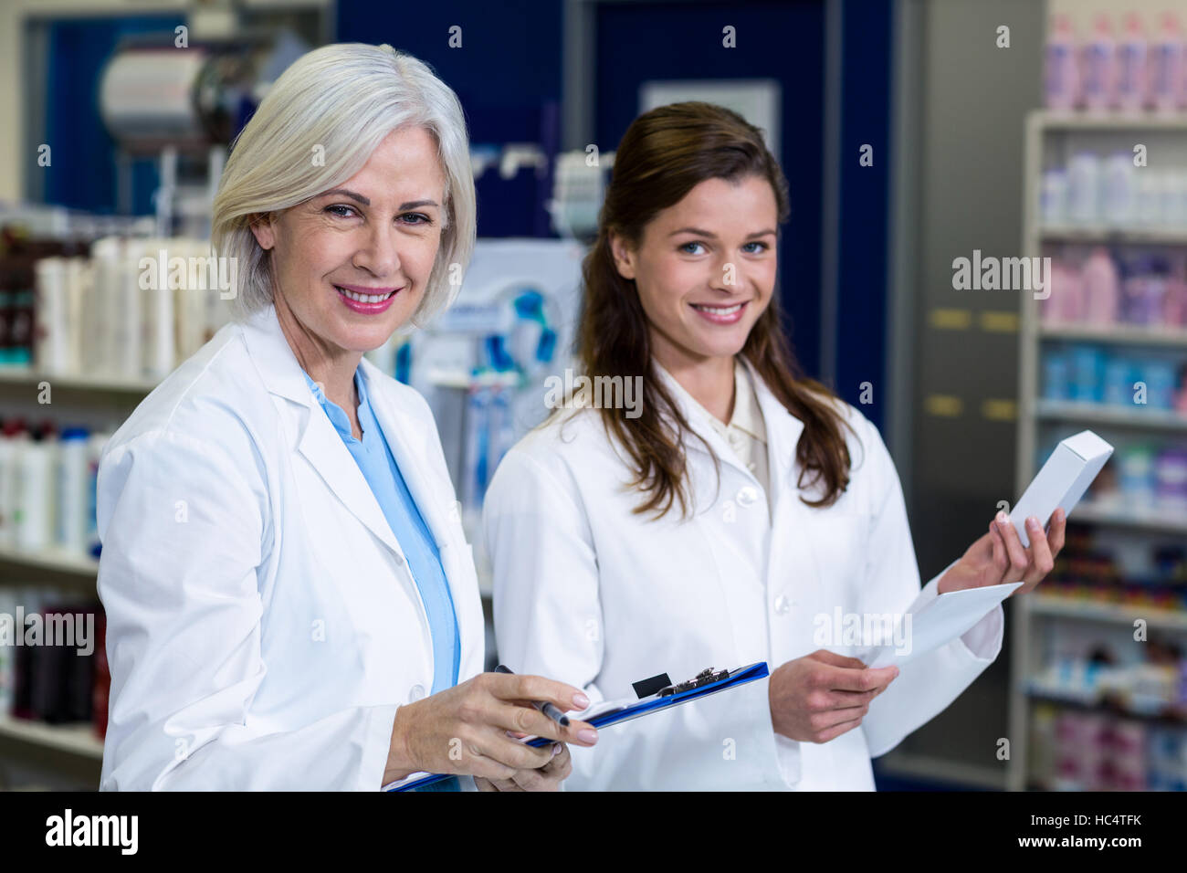 Pharmacists checking and writing prescription for medicine in pharmacy ...