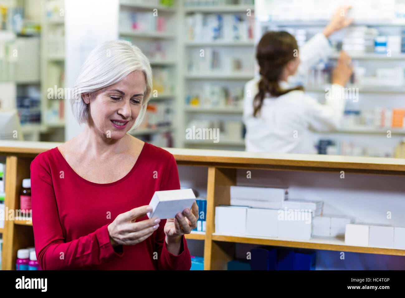 Customer checking a pill box Stock Photo - Alamy