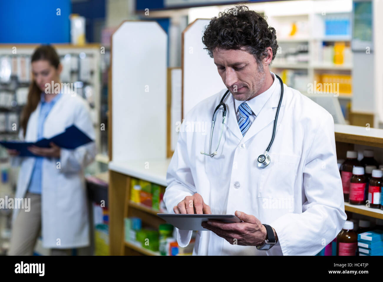 Pharmacist using digital tablet Stock Photo - Alamy