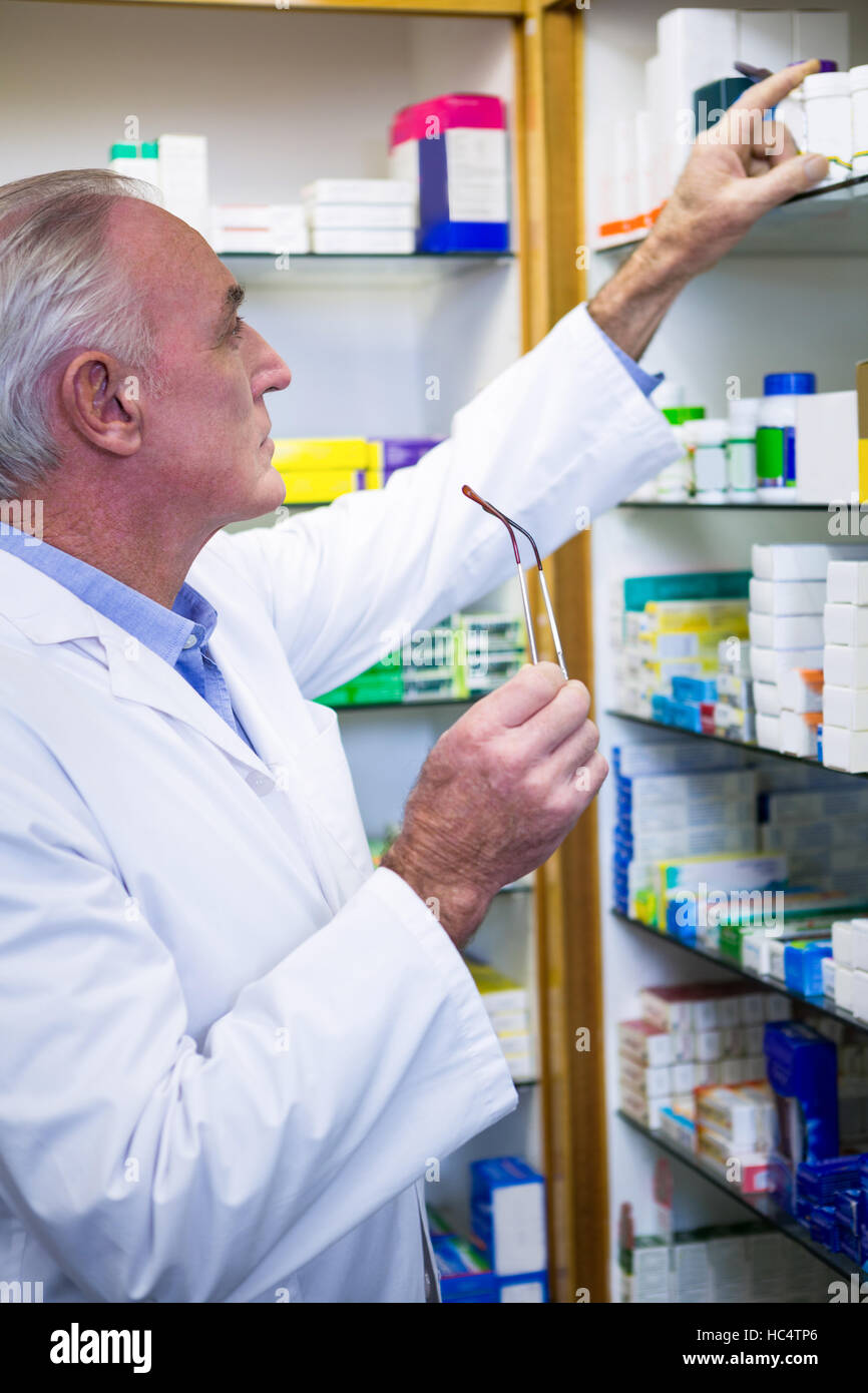 Pharmacist checking medicines in pharmacy Stock Photo - Alamy