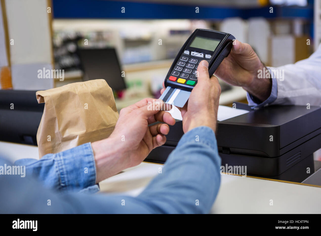 Customer entering pin in payment terminal machine Stock Photo - Alamy