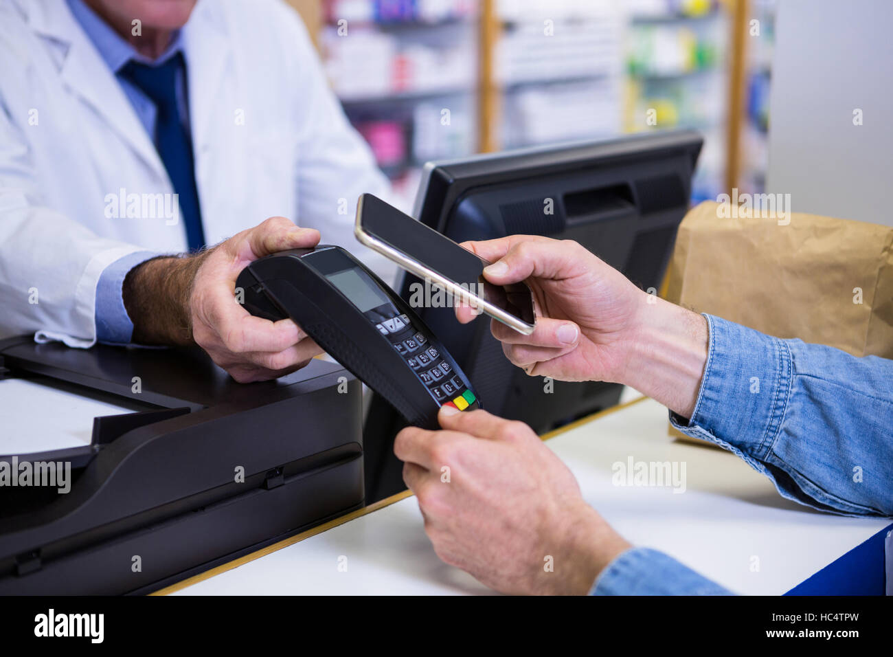 Customer making payment through smartphone in payment terminal Stock ...