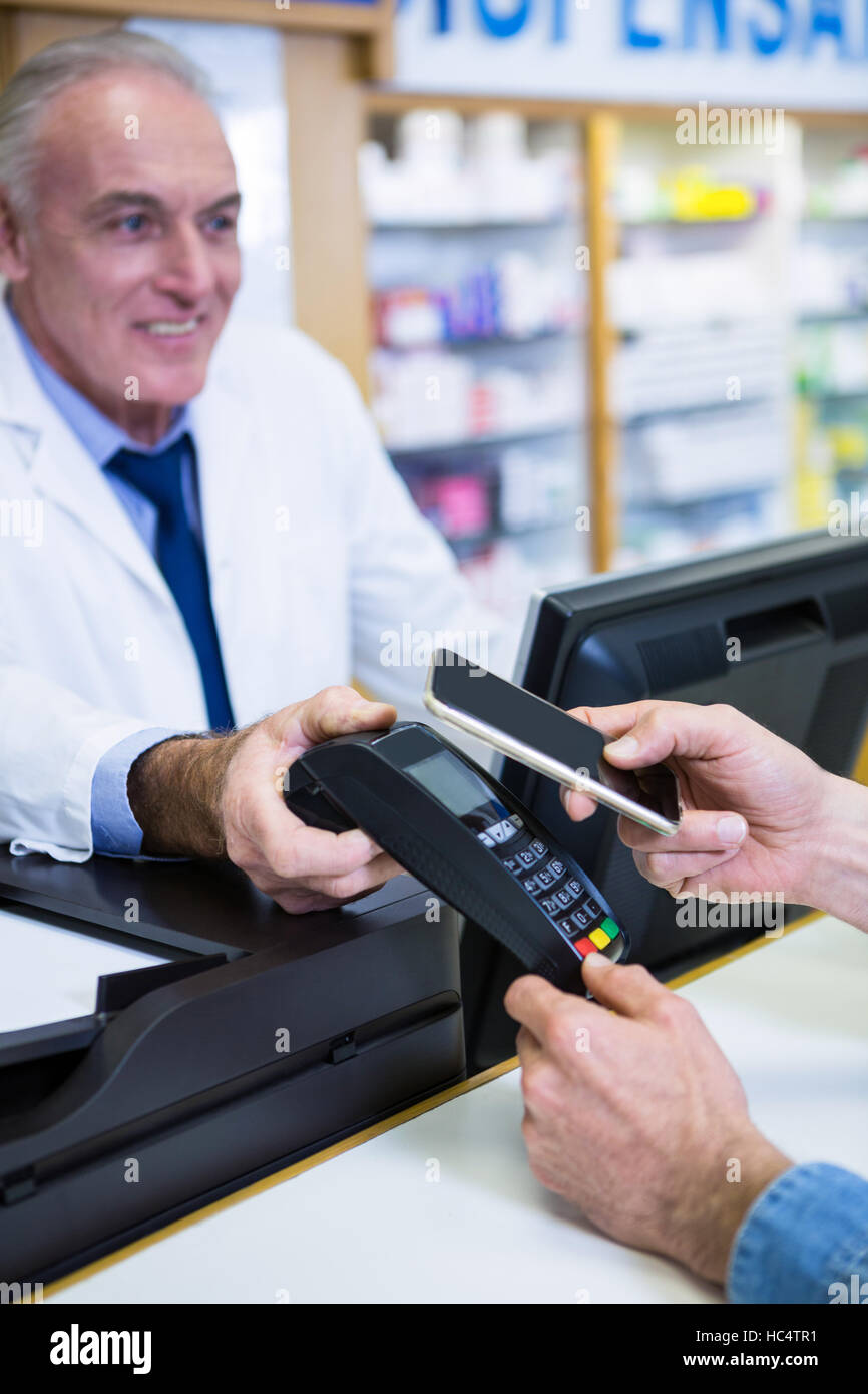 Customer making payment through smartphone in payment terminal Stock ...