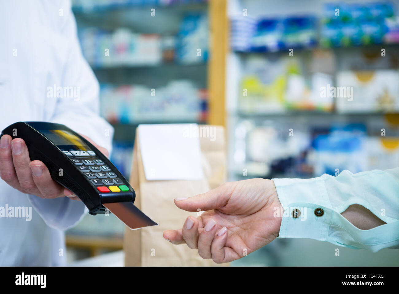 Customer taking credit card from payment terminal Stock Photo - Alamy