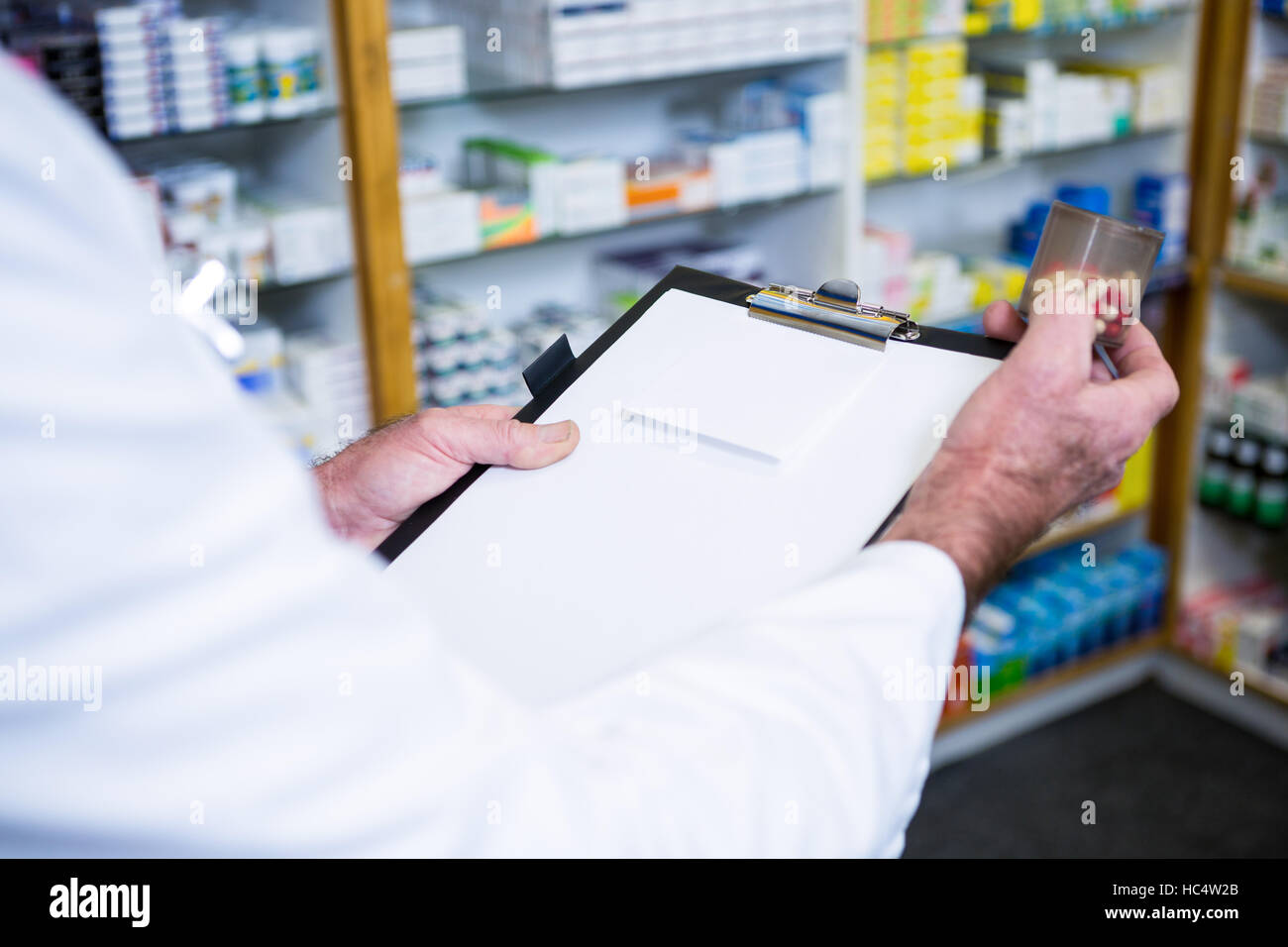 Pharmacist checking medicines Stock Photo - Alamy