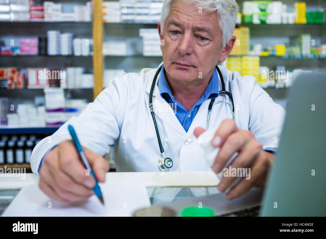 Pharmacist writing prescriptions for medicines Stock Photo - Alamy