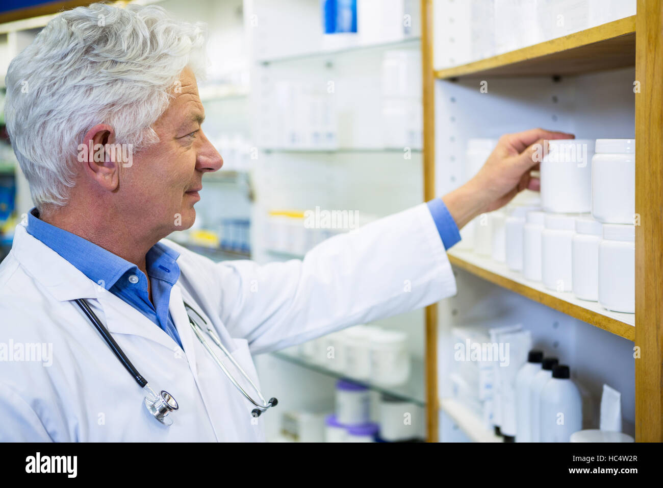 Pharmacist checking medicines in pharmacy Stock Photo - Alamy