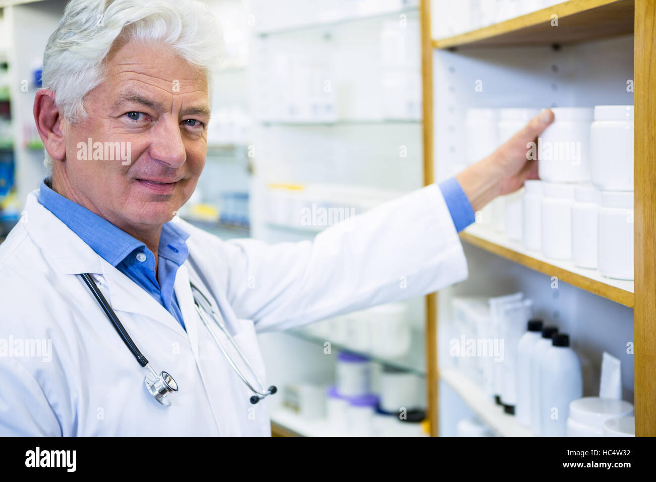 Pharmacist checking medicines in pharmacy Stock Photo - Alamy