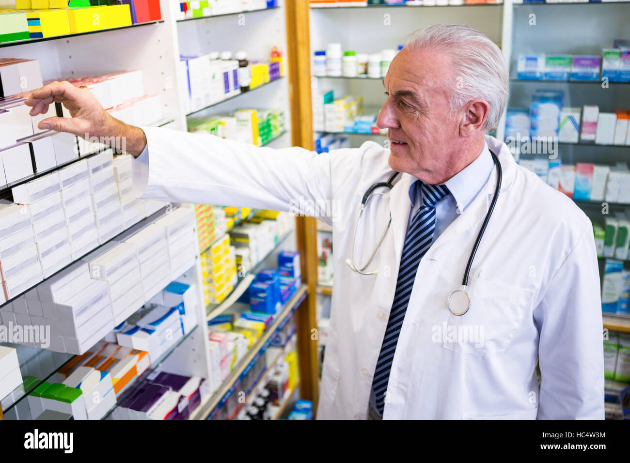 Pharmacist checking medicines in pharmacy Stock Photo - Alamy