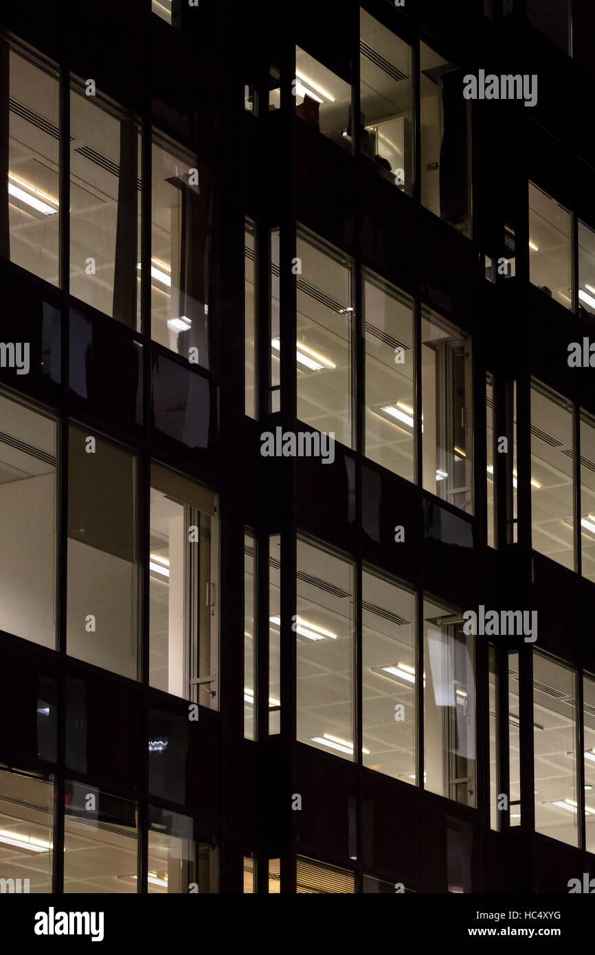 View of an office block in central London at night with windows glowing ...