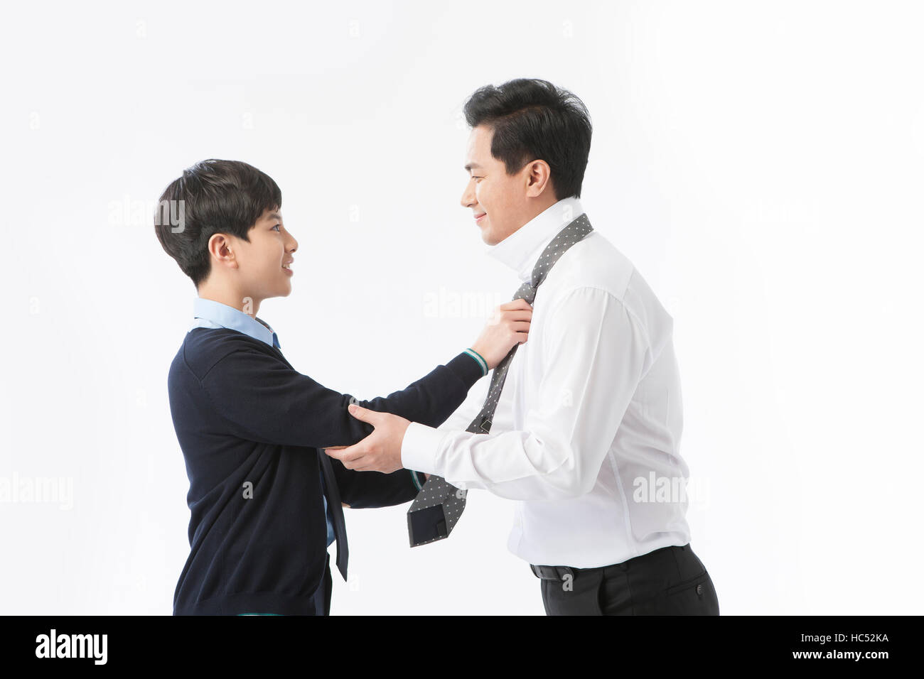 Side view portrait of son helping his father wearing tie Stock Photo ...