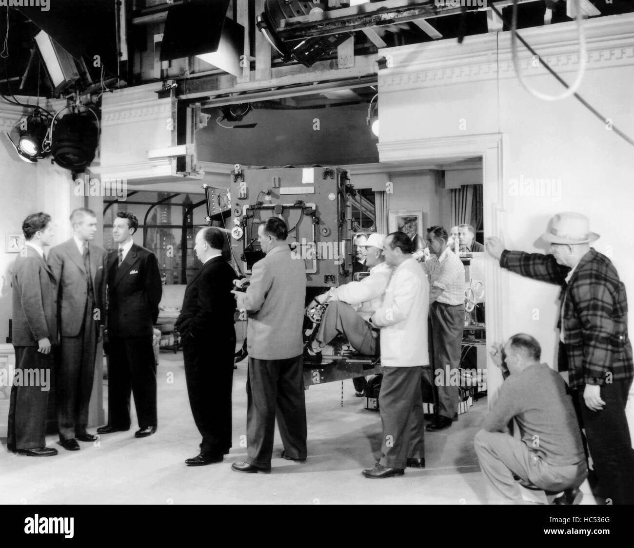 ROPE, Alfred Hitchcock, in black suit, directing, from left, Farley ...